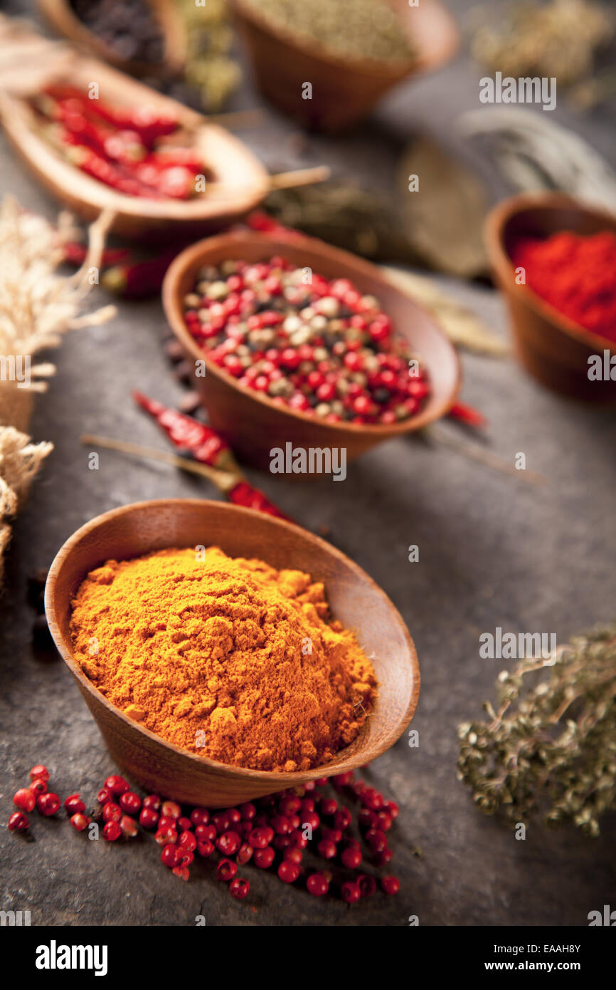 Various spices in wooden bowls on stone surface Stock Photo - Alamy