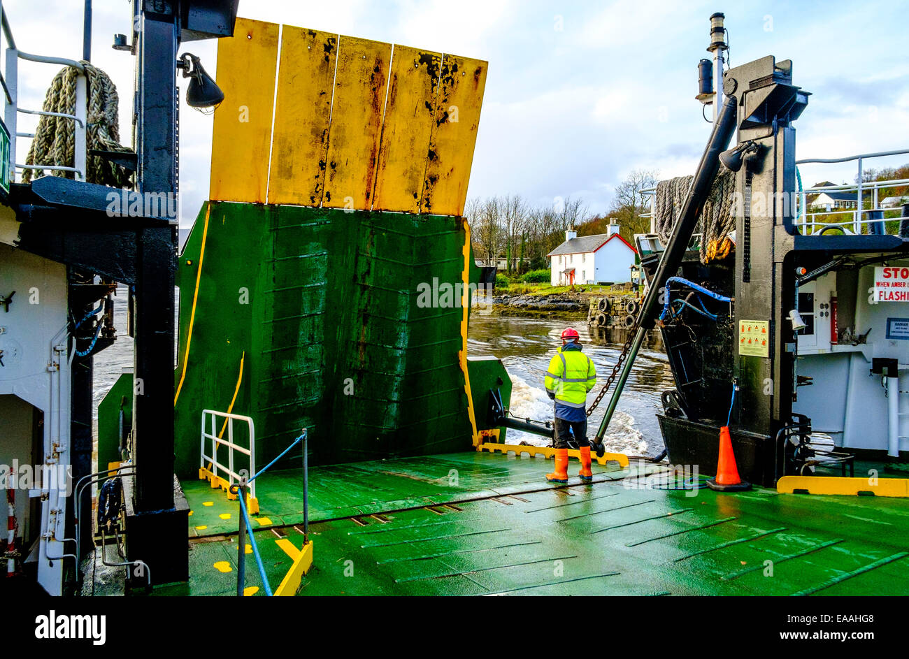 A deckhand prepares to lower the ramp on the car ferry from Fishnish in ...