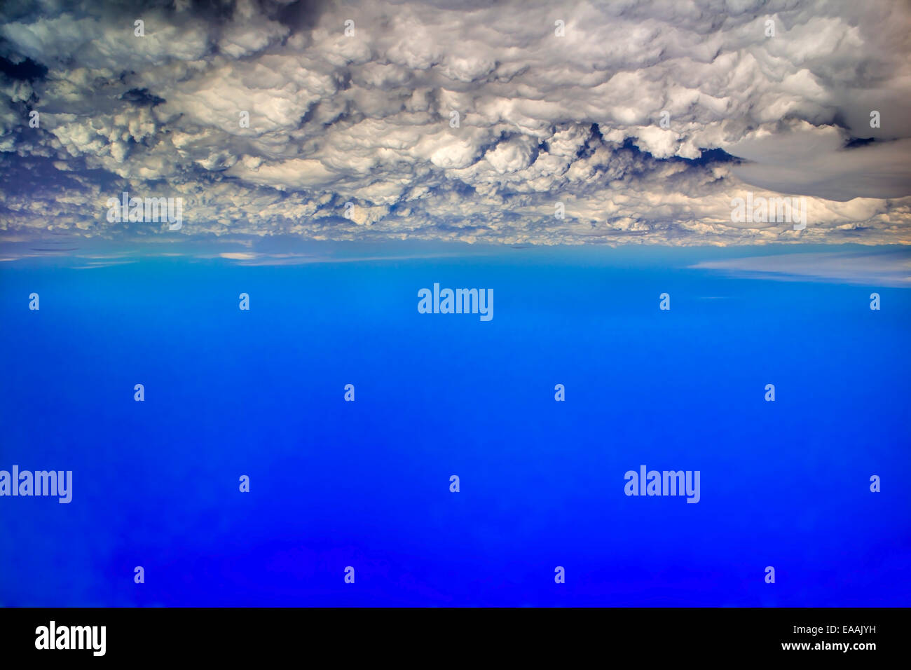 Cloudscape with deep blue sky upside down Stock Photo - Alamy