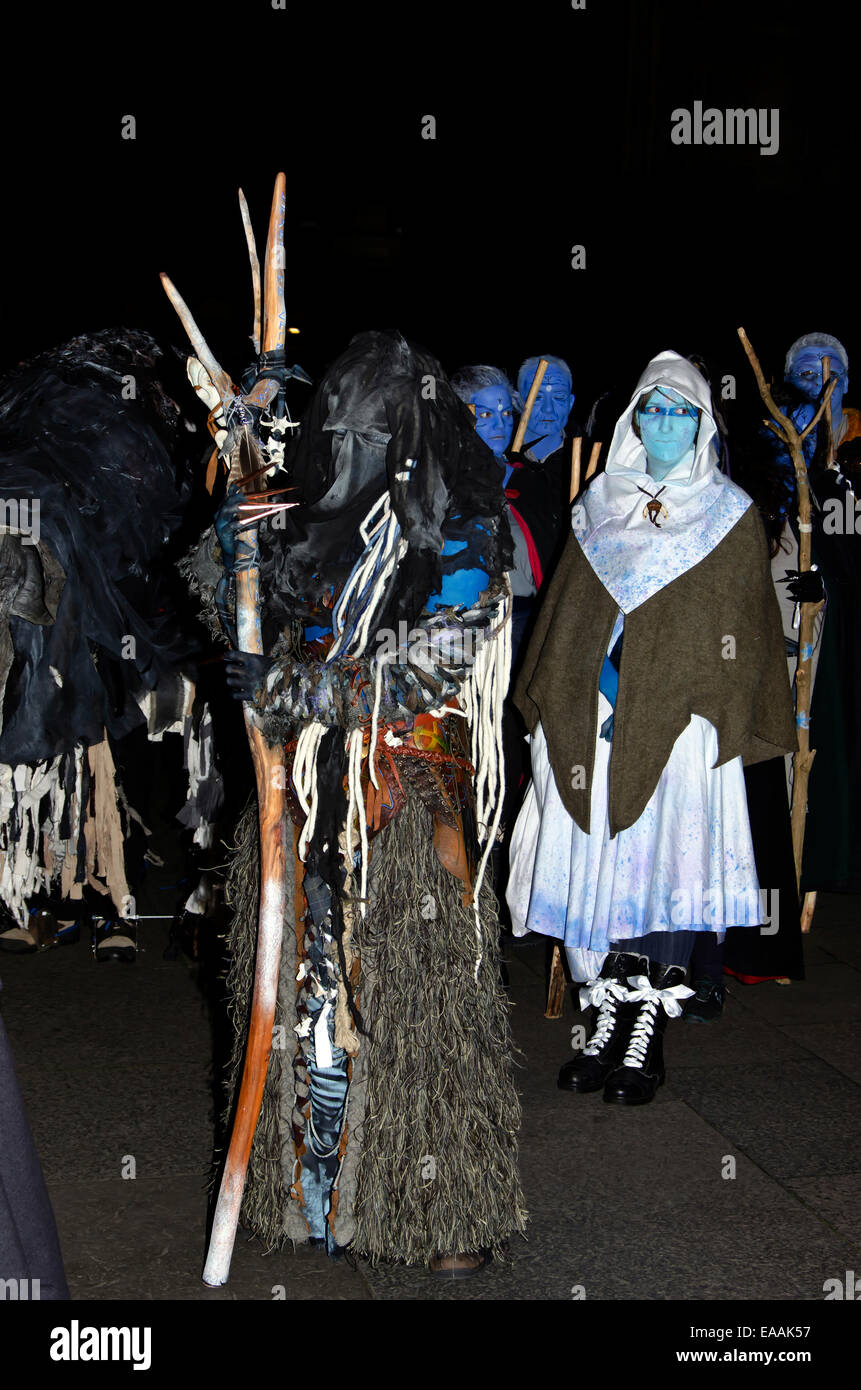 Scary, faceless character and blue-painted people taking part in the ...
