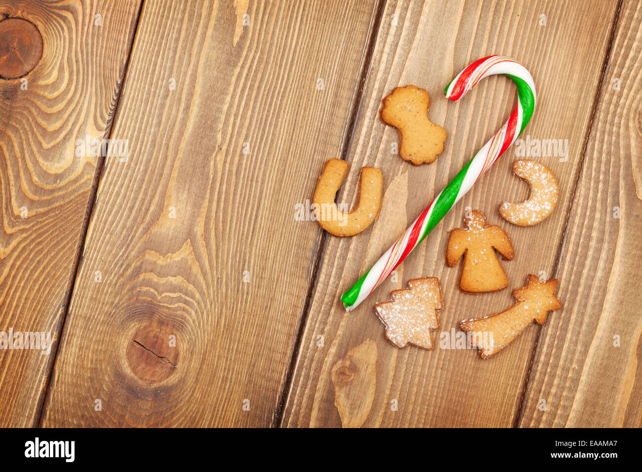 Homemade christmas gingerbread cookies and candy cane on wooden ...