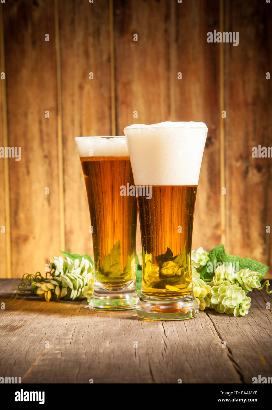 Glass of beers on wooden table Stock Photo - Alamy
