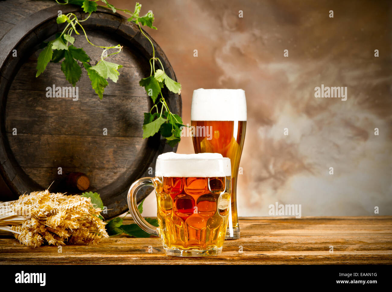Beer keg with glasses of beer and blur background Stock Photo - Alamy