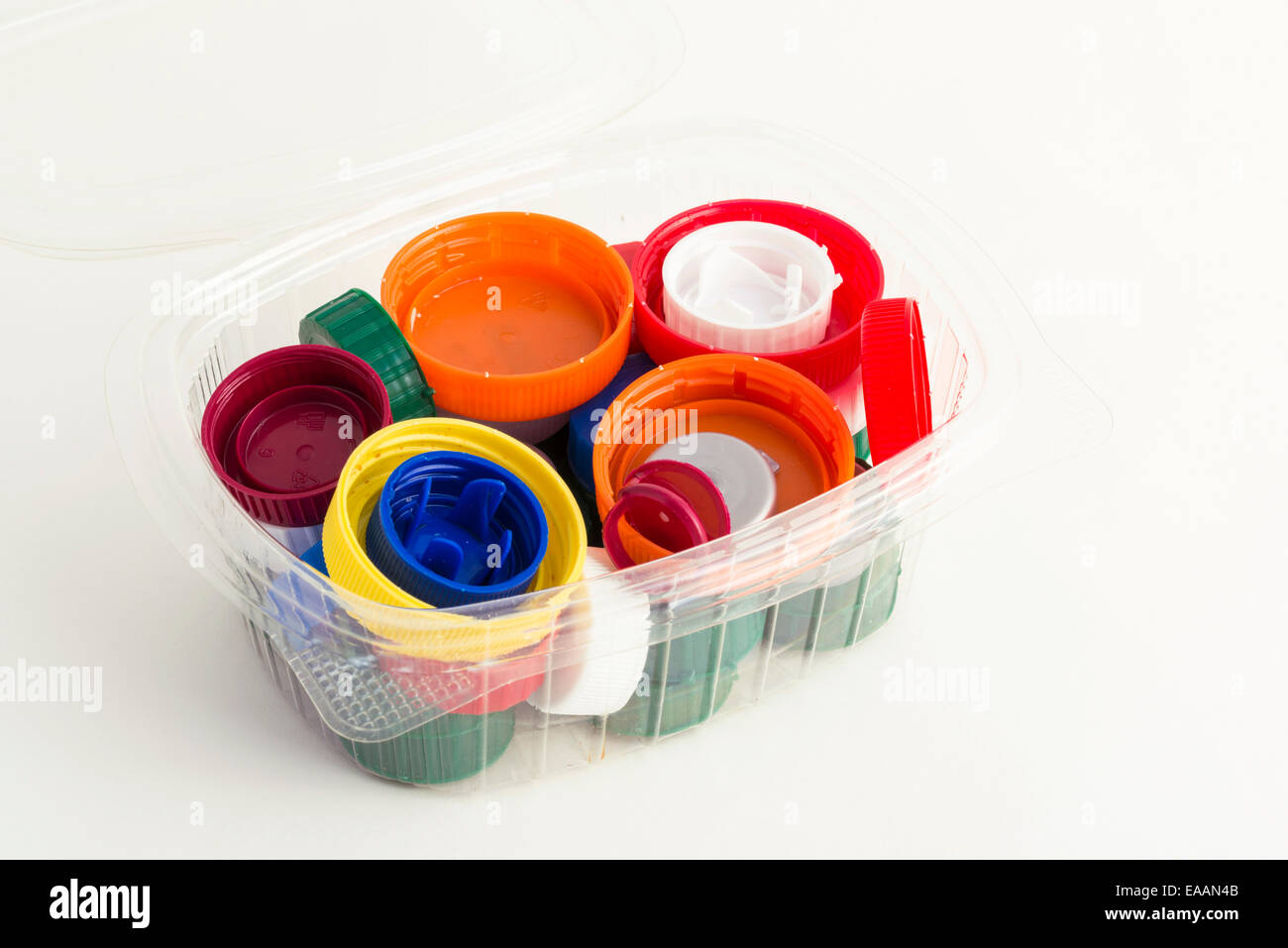 lots of plastic plugs in a plastic container isolated on white ...