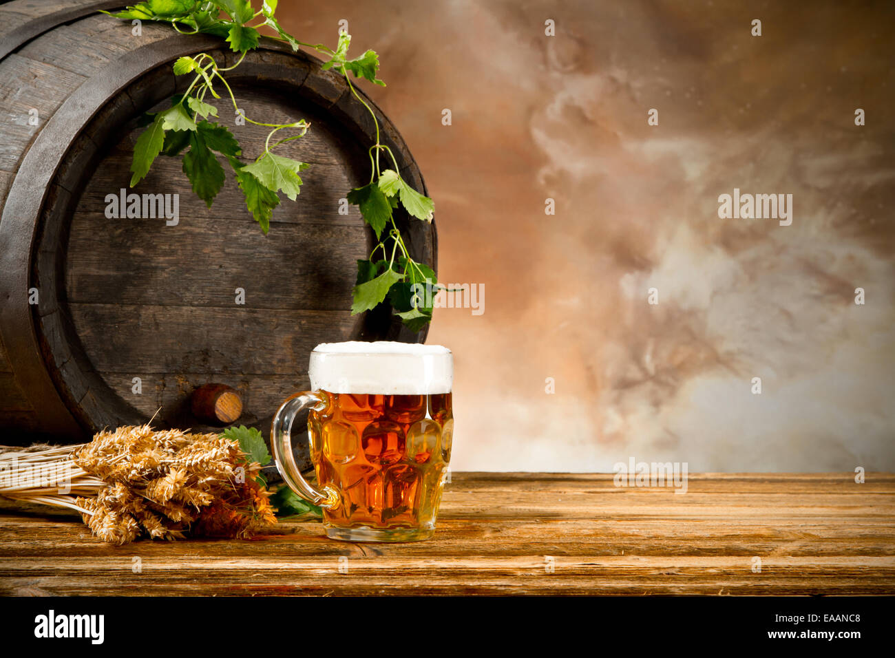 Beer keg with glass of beer and blur background Stock Photo - Alamy
