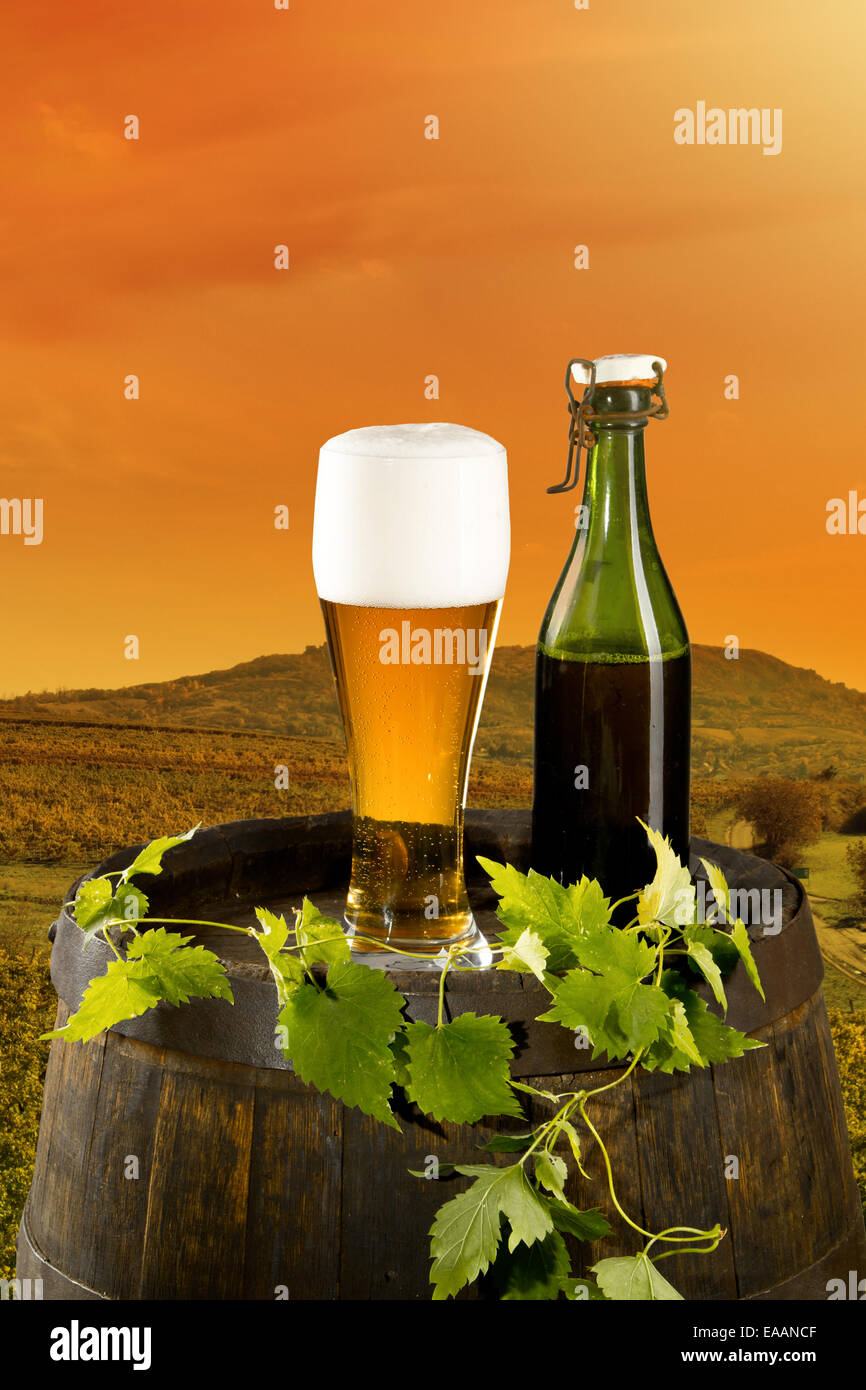 Beer keg with glass of beer on rural countryside background Stock Photo ...