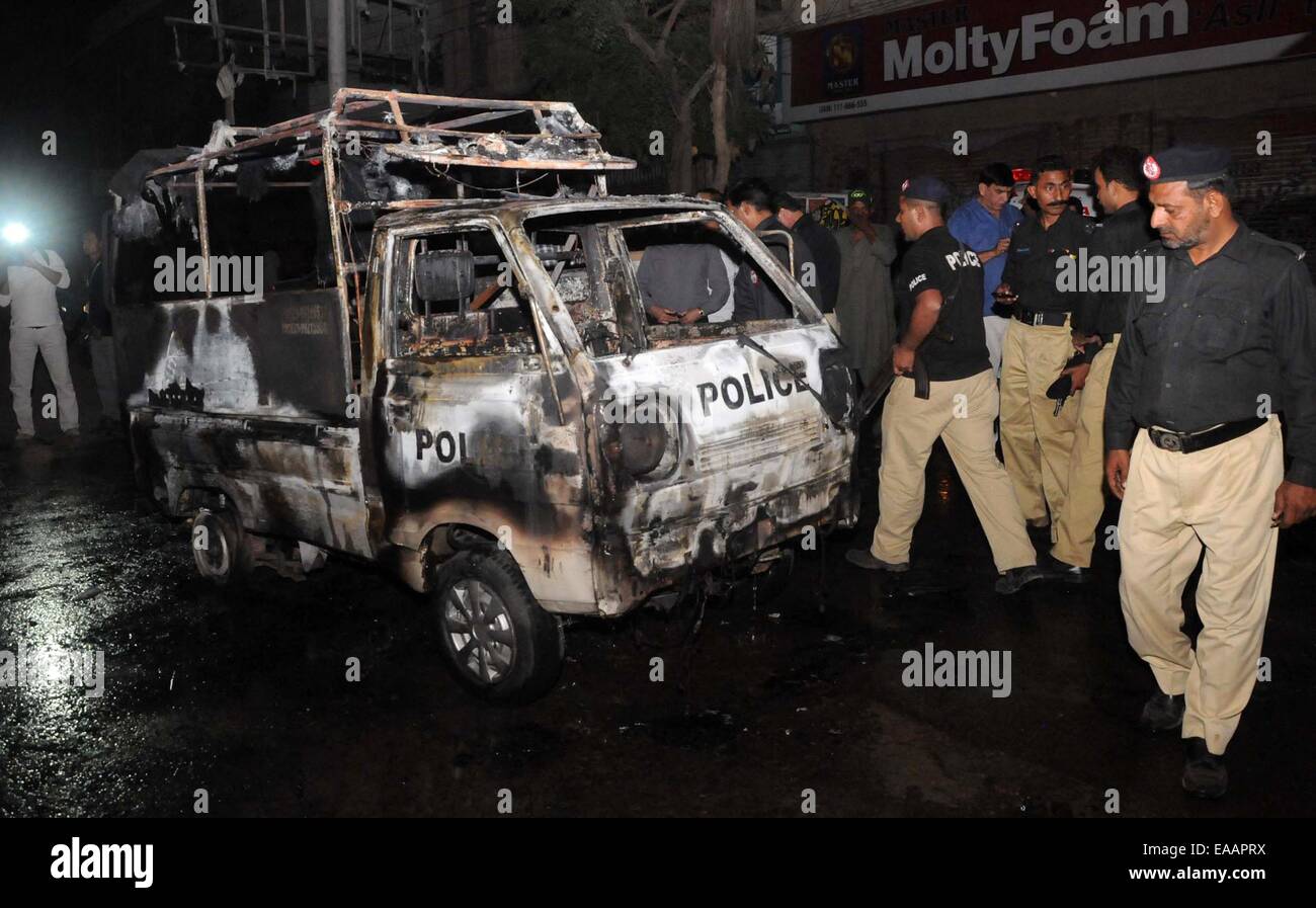 Karachi, Pakistan. 10th Nov, 2014. Policeman examine a burnt van at the ...