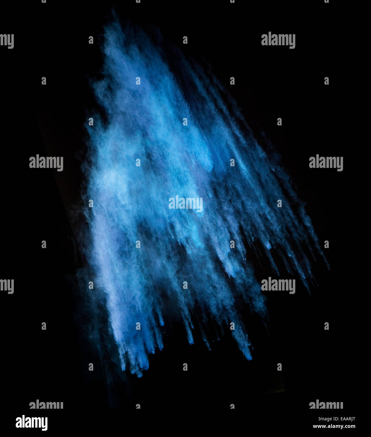 Freeze motion of blue dust explosion isolated on black background Stock ...