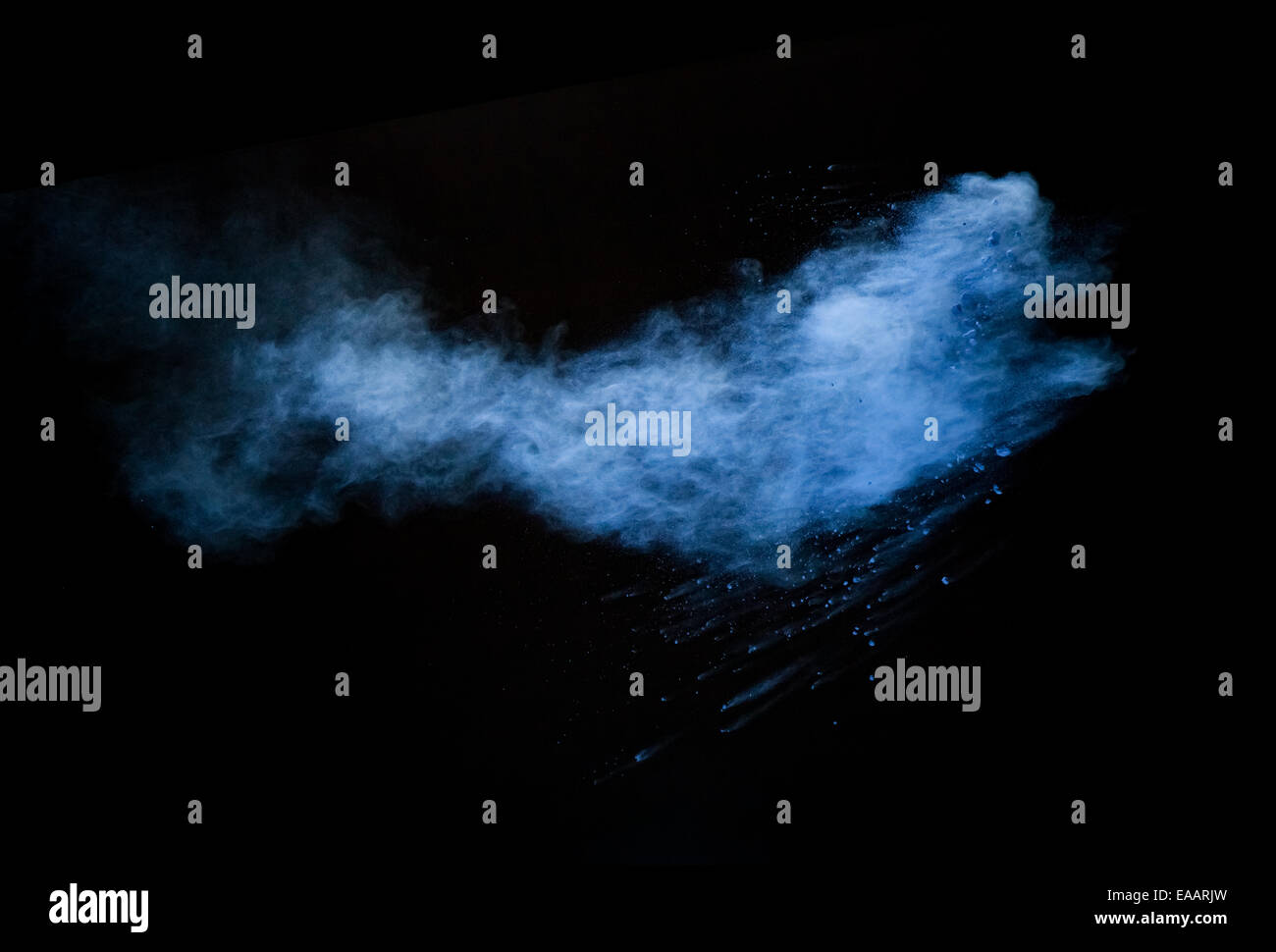 Freeze motion of blue dust explosion isolated on black background Stock ...