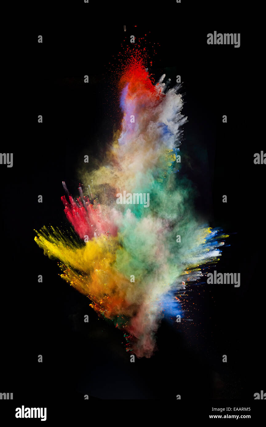 Freeze motion of colored dust explosion isolated on black background ...
