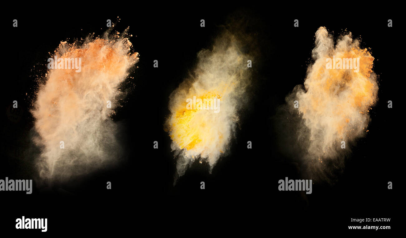 Freeze motion of yellow dust explosion isolated on black background ...