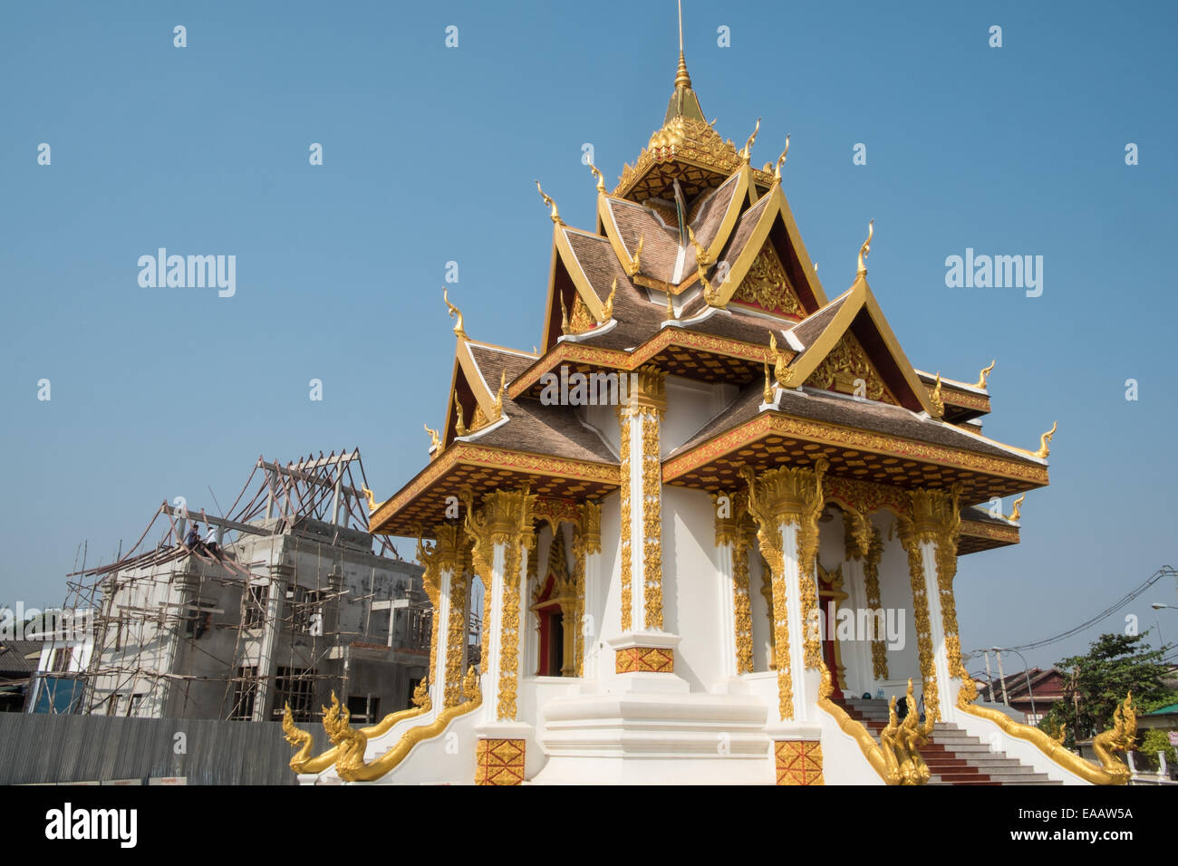 Buddhist temple and new residential construction in centre of Vientiane ...