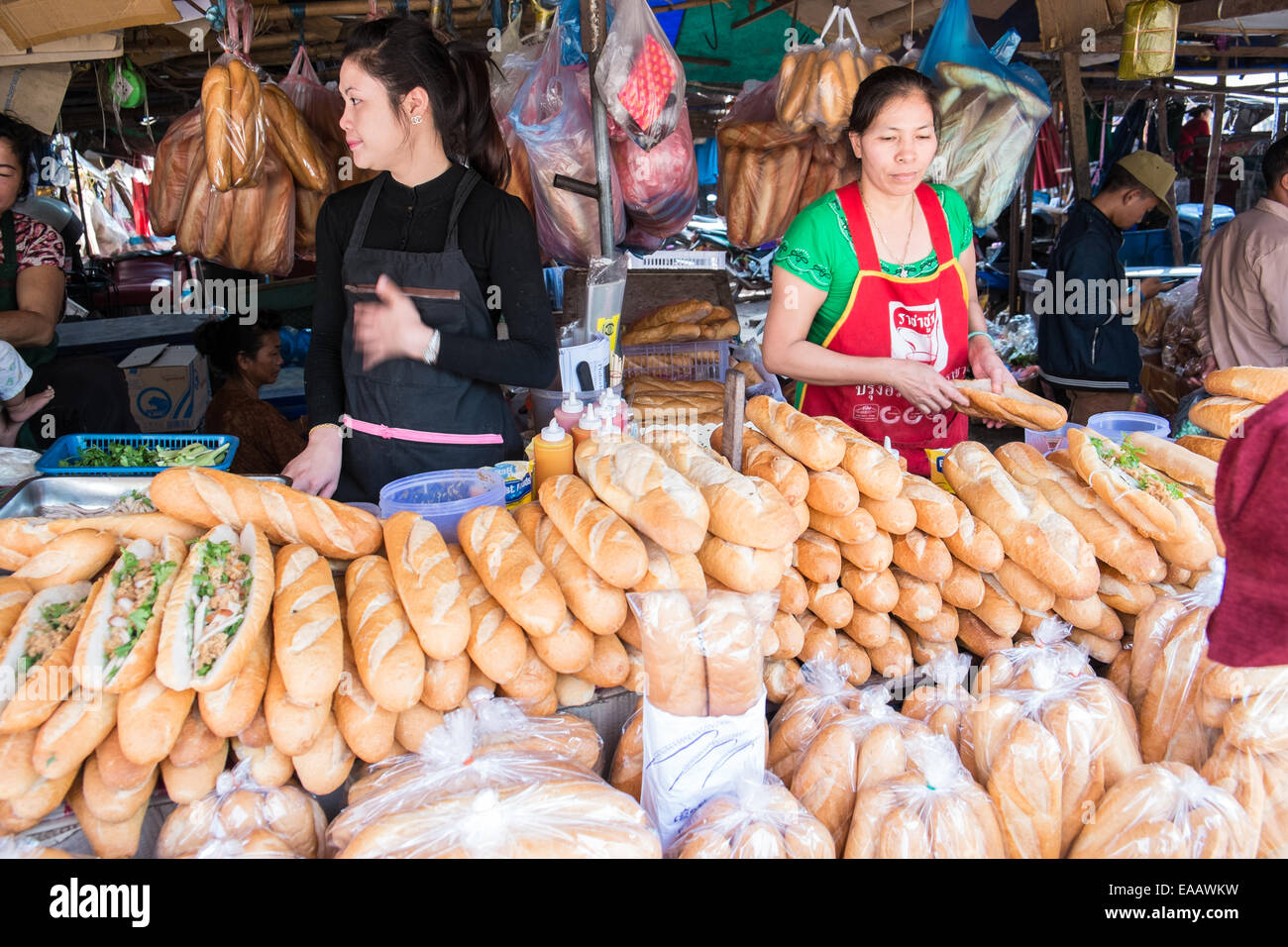 Women making sandwich filling with baguettes,French stick bread at this ...