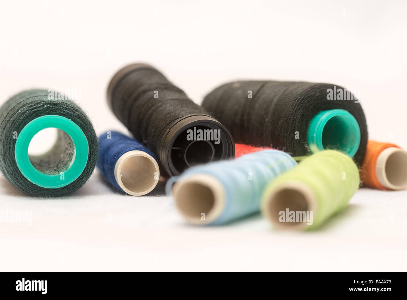 set of colorful spools of thread on a white background Stock Photo - Alamy