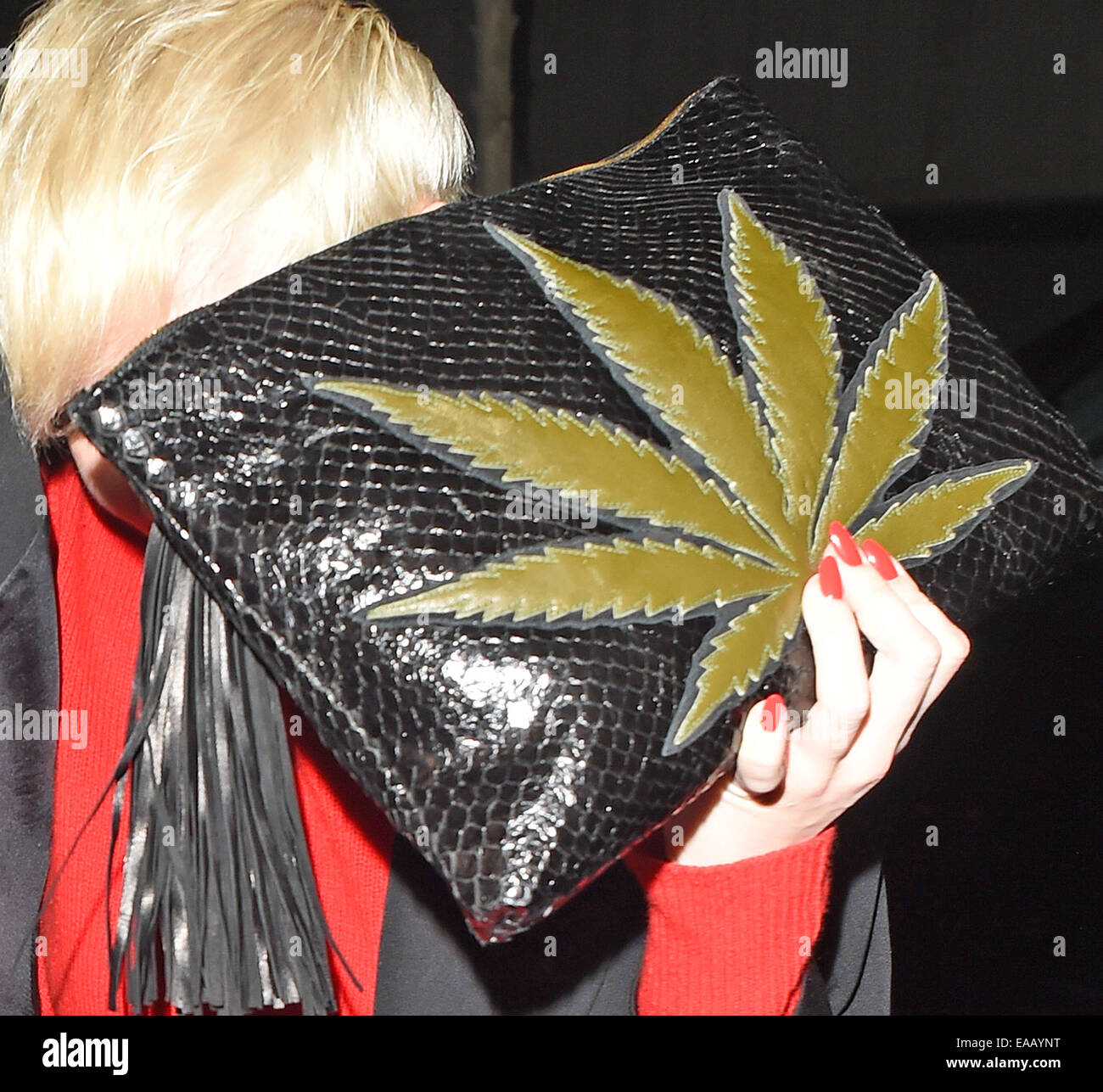 Miley Cirus arriving at Claridge's hotel holding a cannabis leaf logo ...