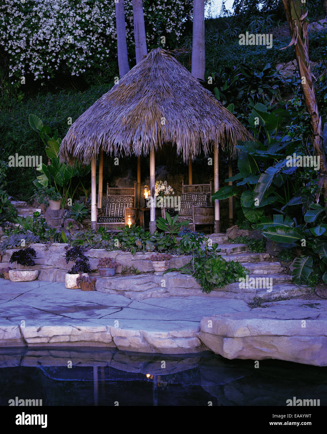 Poolside Hut with chairs and candles Stock Photo - Alamy
