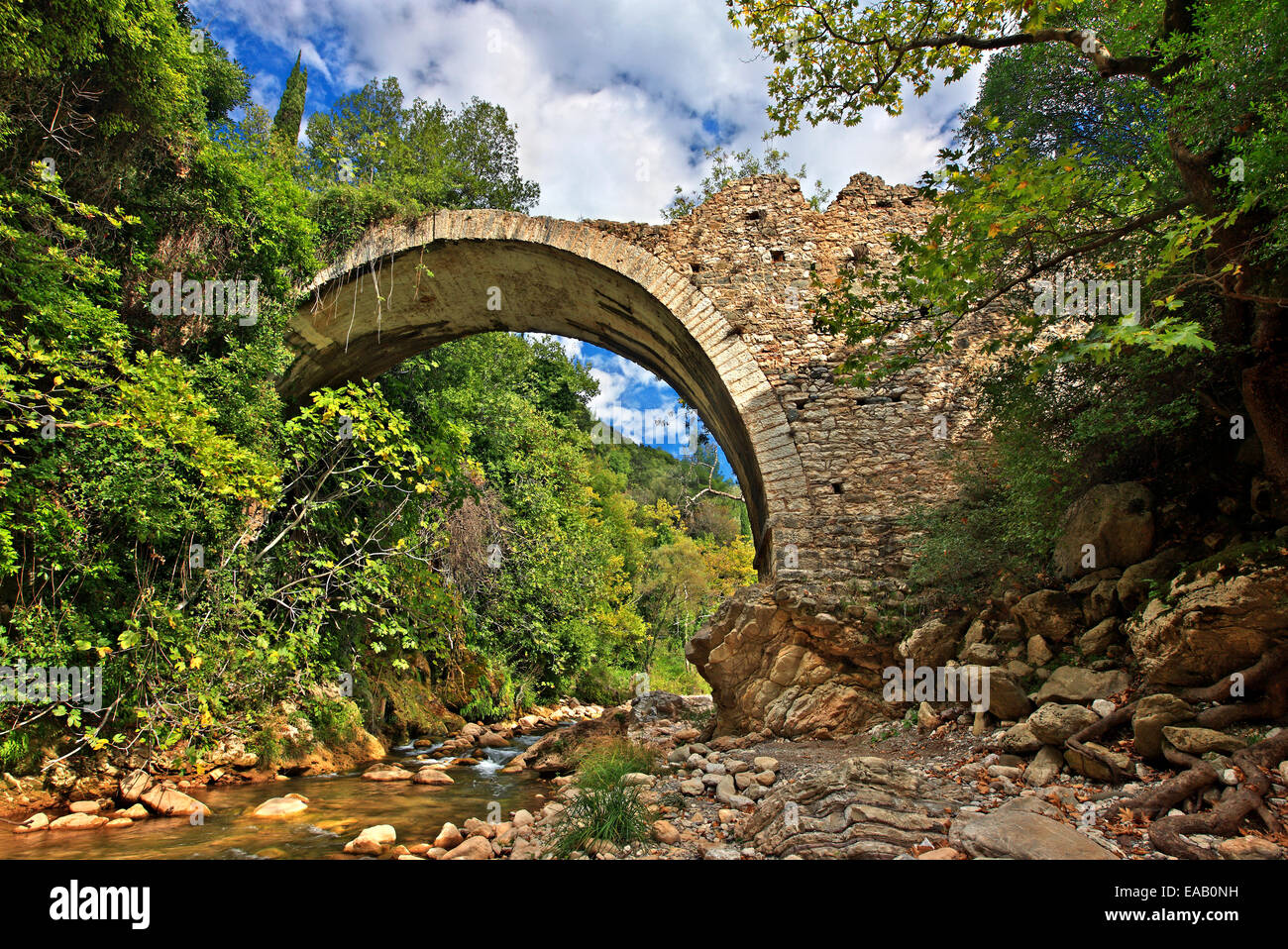 Old stone arched bridge over Neda river, in Neda canyon, at the ...