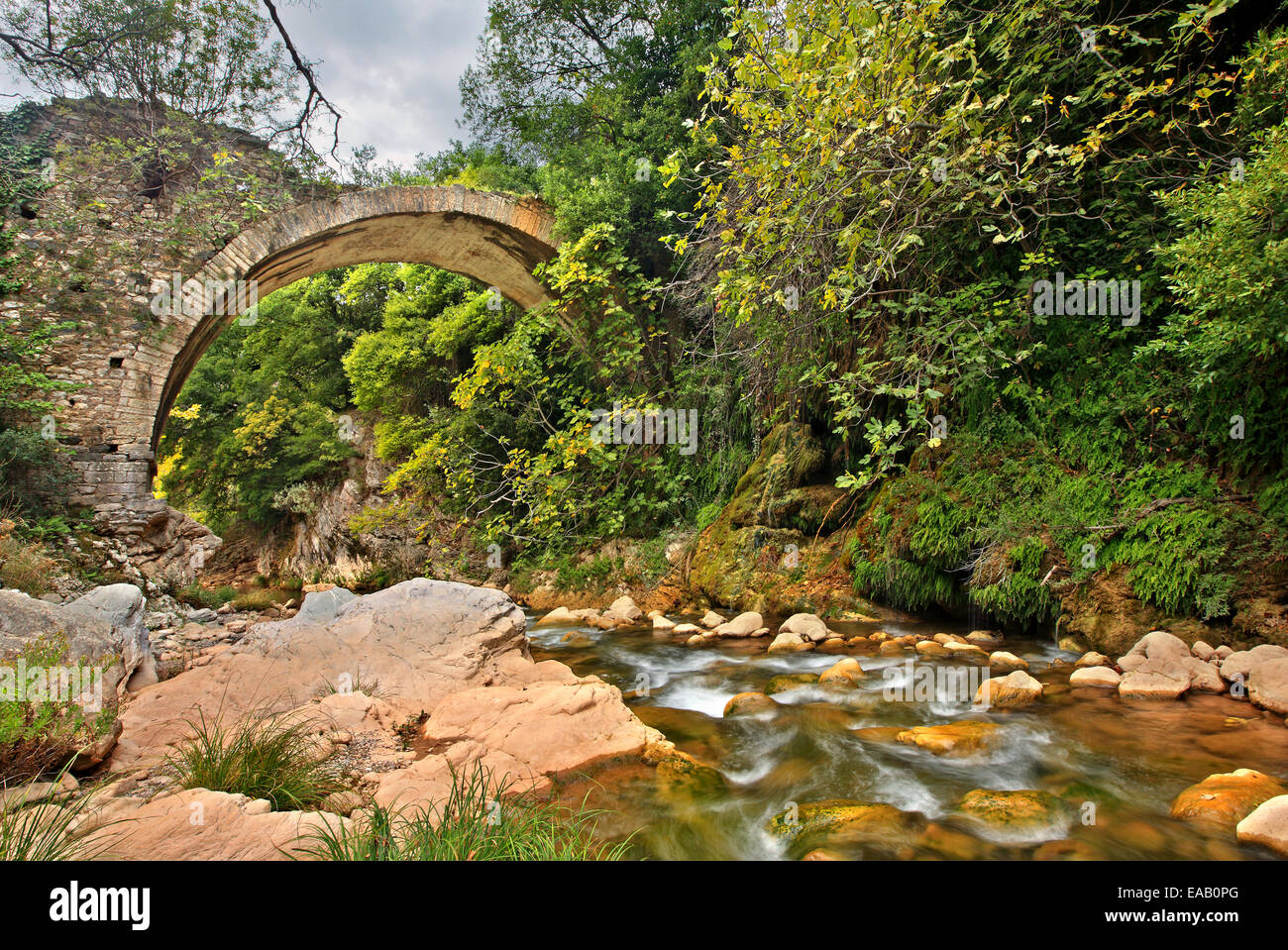 Old stone arched bridge over Neda river, in Neda canyon, at the ...