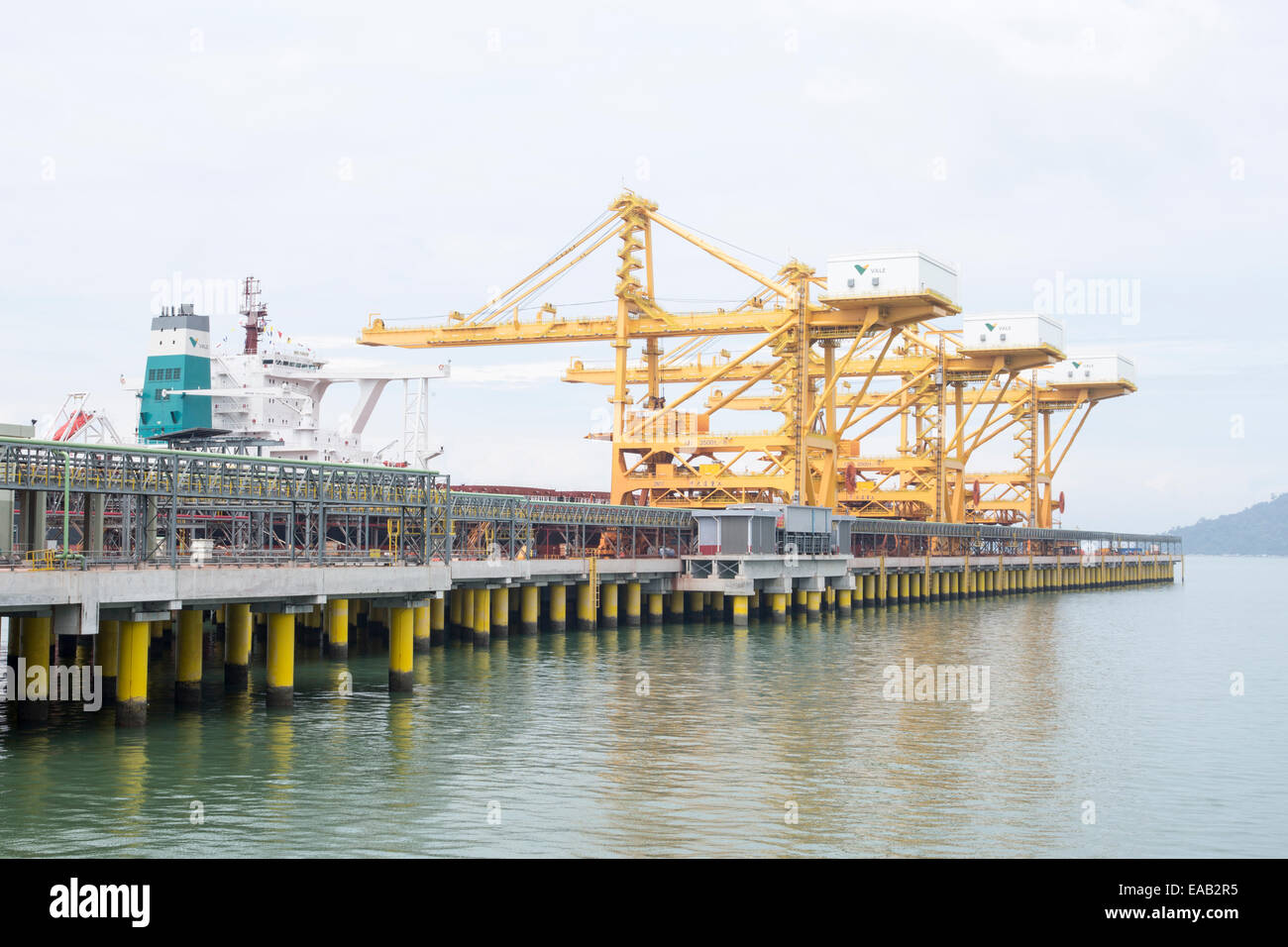 A bulk carrier ship sits berthed next to ship loaders at the pier Vale ...