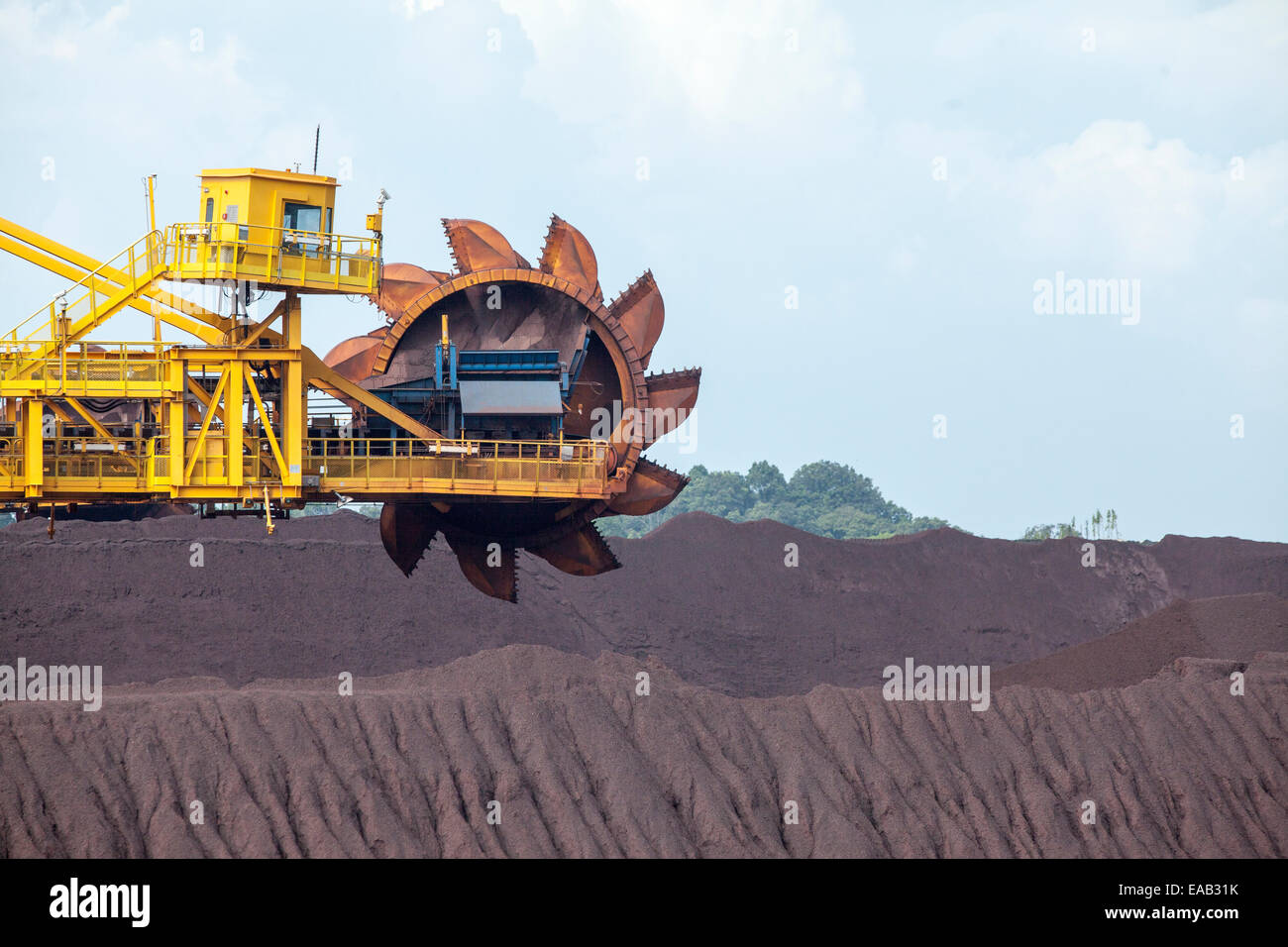 Stackers stand next to piles of iron ore Vale SA's Teluk Rubiah ...