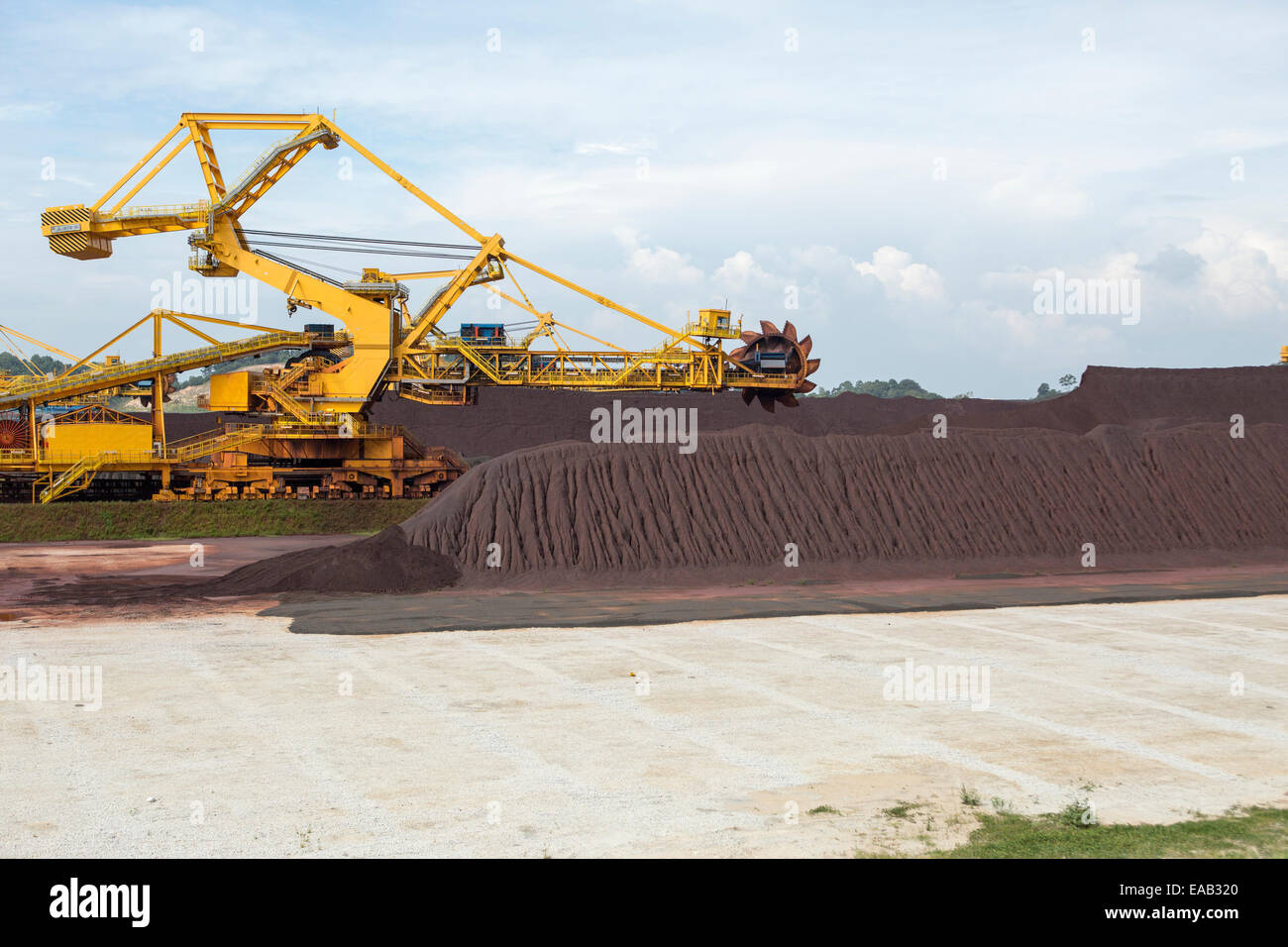 Stackers stand next to piles of iron ore Vale SA's Teluk Rubiah ...