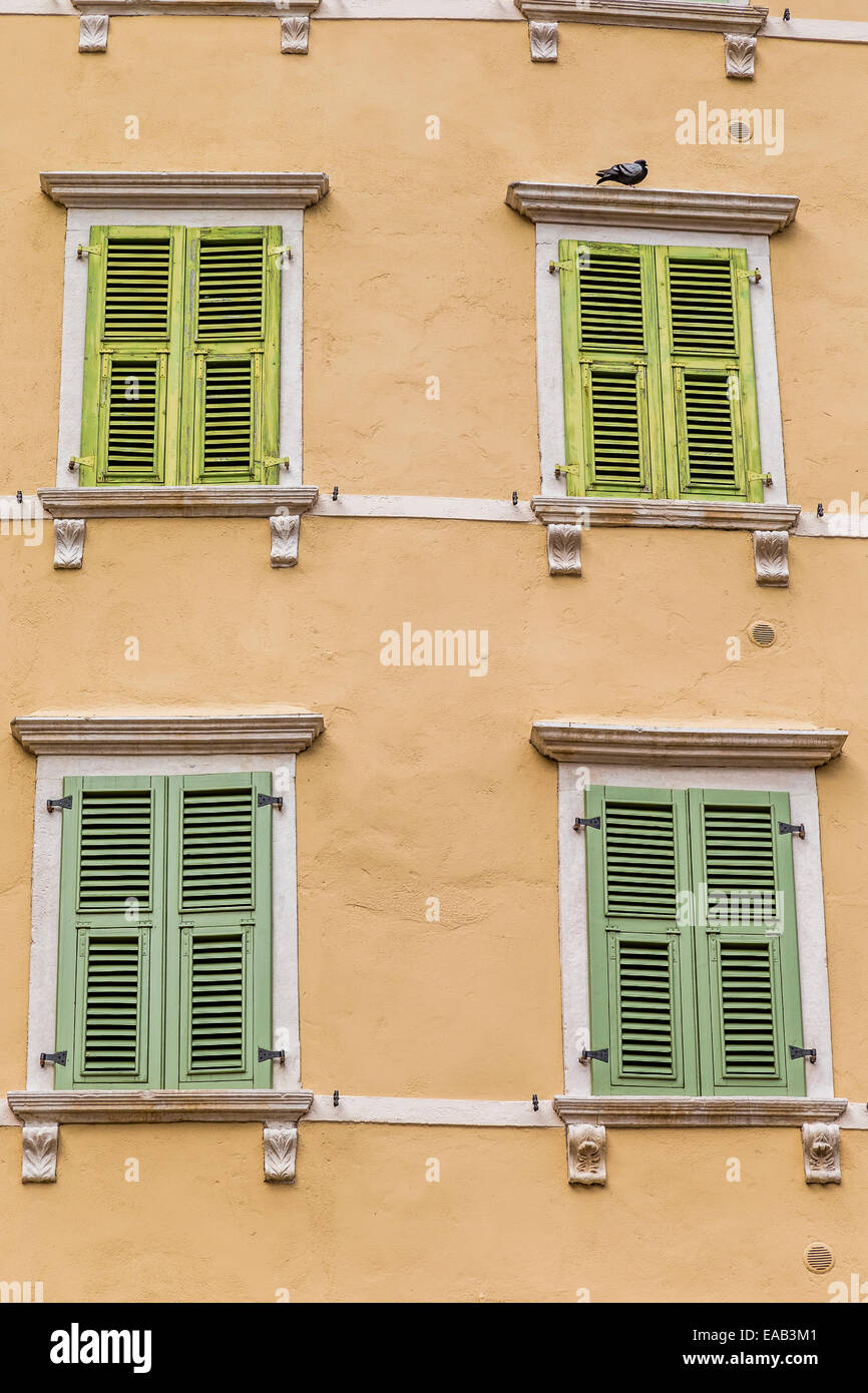 Shuttered windows on a colourful building in old town Riva Del Garda ...