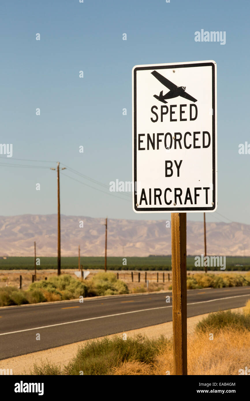 A speed enforced by aircraft sign on a road in the Central Valley of ...
