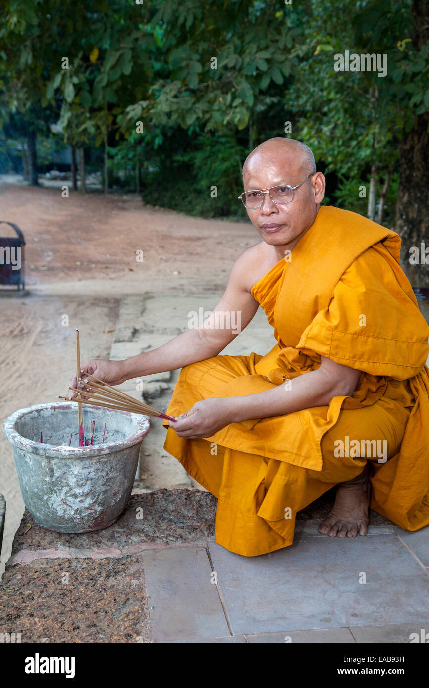 Cambodia, Bayon. Buddhist Monk Placing Incense Sticks Stock Photo - Alamy