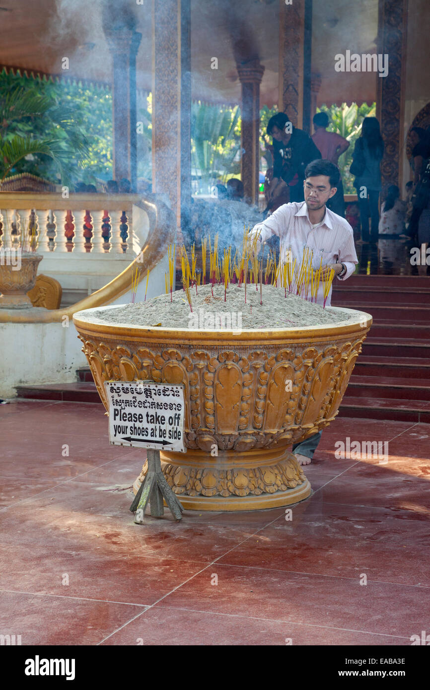 Cambodia, Siem Reap. Worshiper Placing Incense at Preah Ang Chek and ...