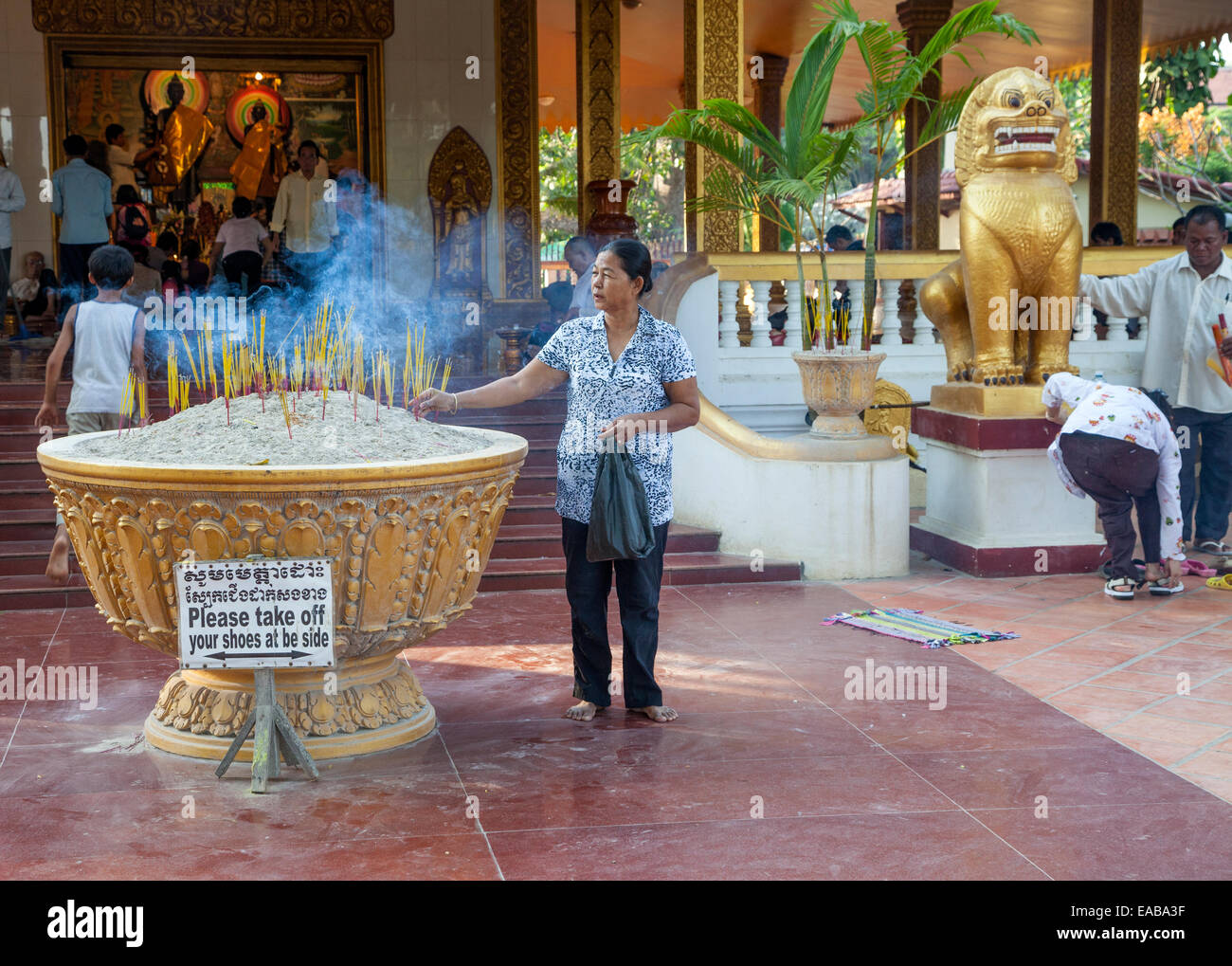 Cambodia, Siem Reap. Worshiper Placing Incense at Preah Ang Chek and ...