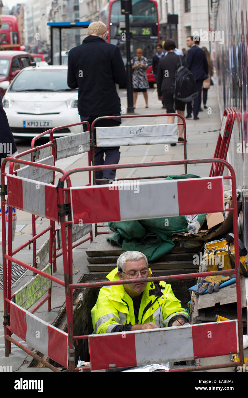 British telecom engineer working in street with barriers Stock Photo ... British telecom engineer working in street with barriers Stock Photo ...