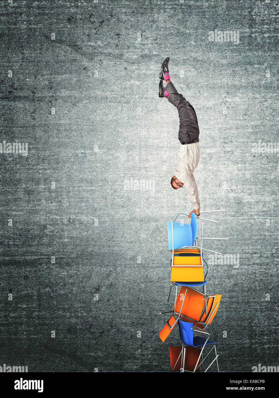 man try acrobat on pile of chairs Stock Photo - Alamy