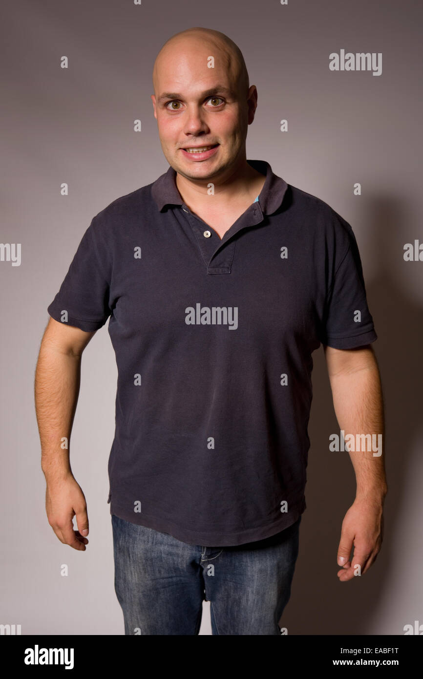 Portrait of young silly man on a dark background Stock Photo - Alamy