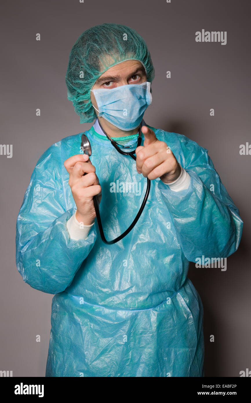 young mal doctor pointing, on a dark background Stock Photo - Alamy