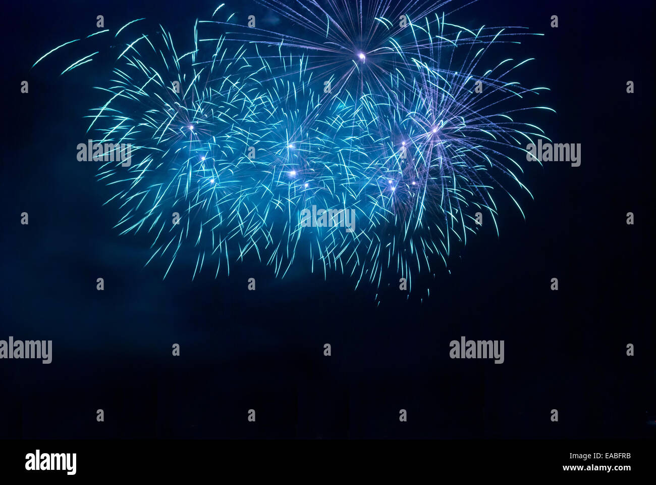 Blue fireworks on the black sky background Stock Photo - Alamy