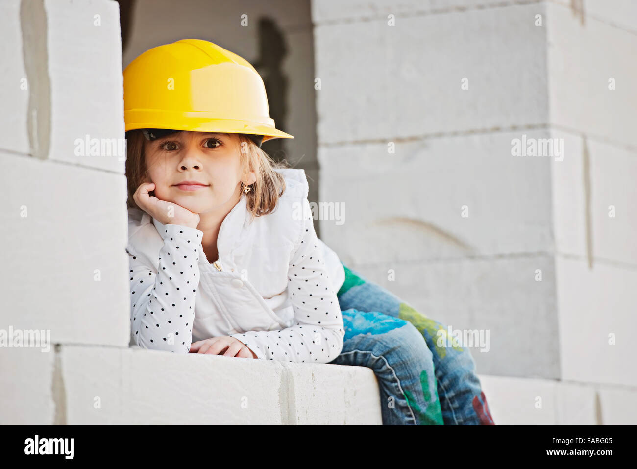 little girl with helmet working on construction Stock Photo - Alamy