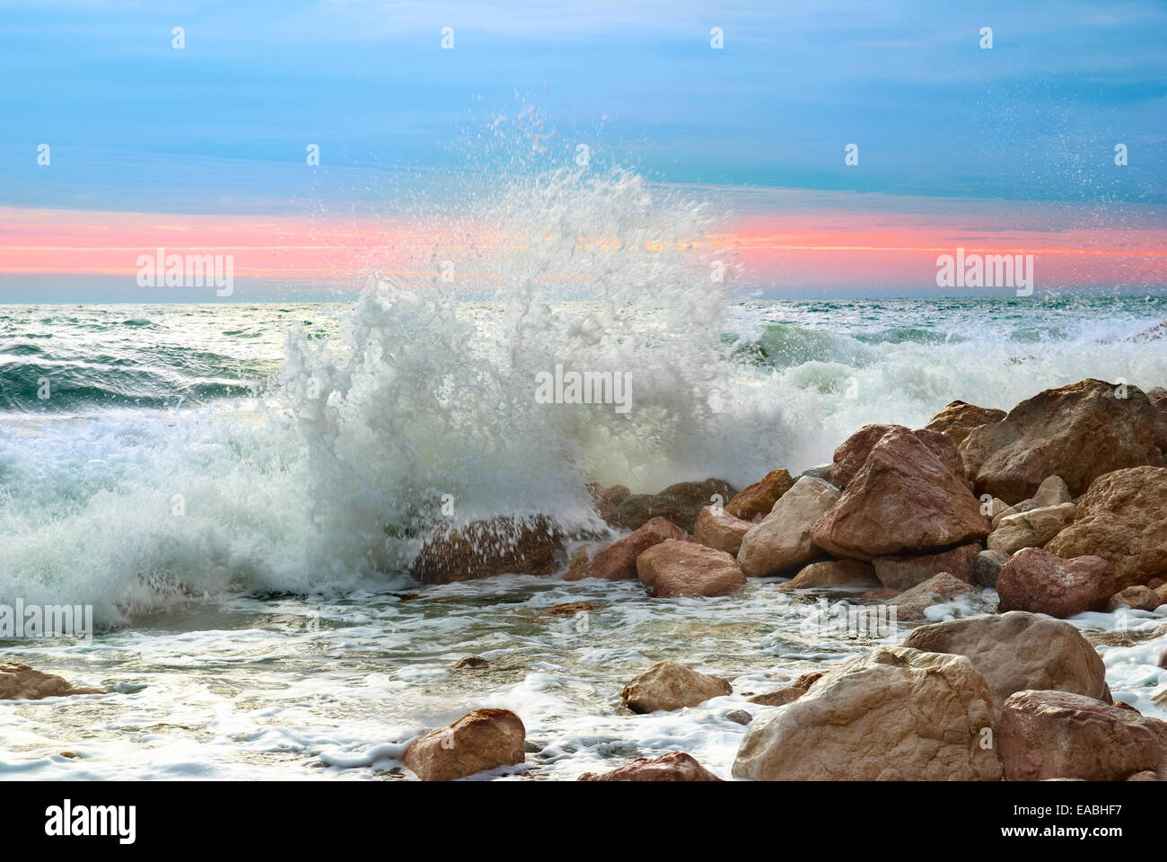 Sea landscape with waves on the beach against sunset Stock Photo - Alamy
