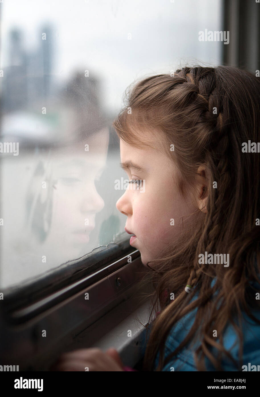 Girl looking out window Stock Photo - Alamy