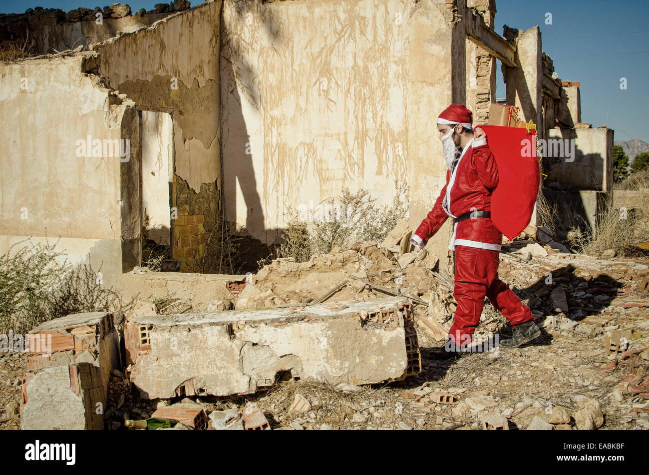 A fed up Santa trudging along with his sack Stock Photo - Alamy