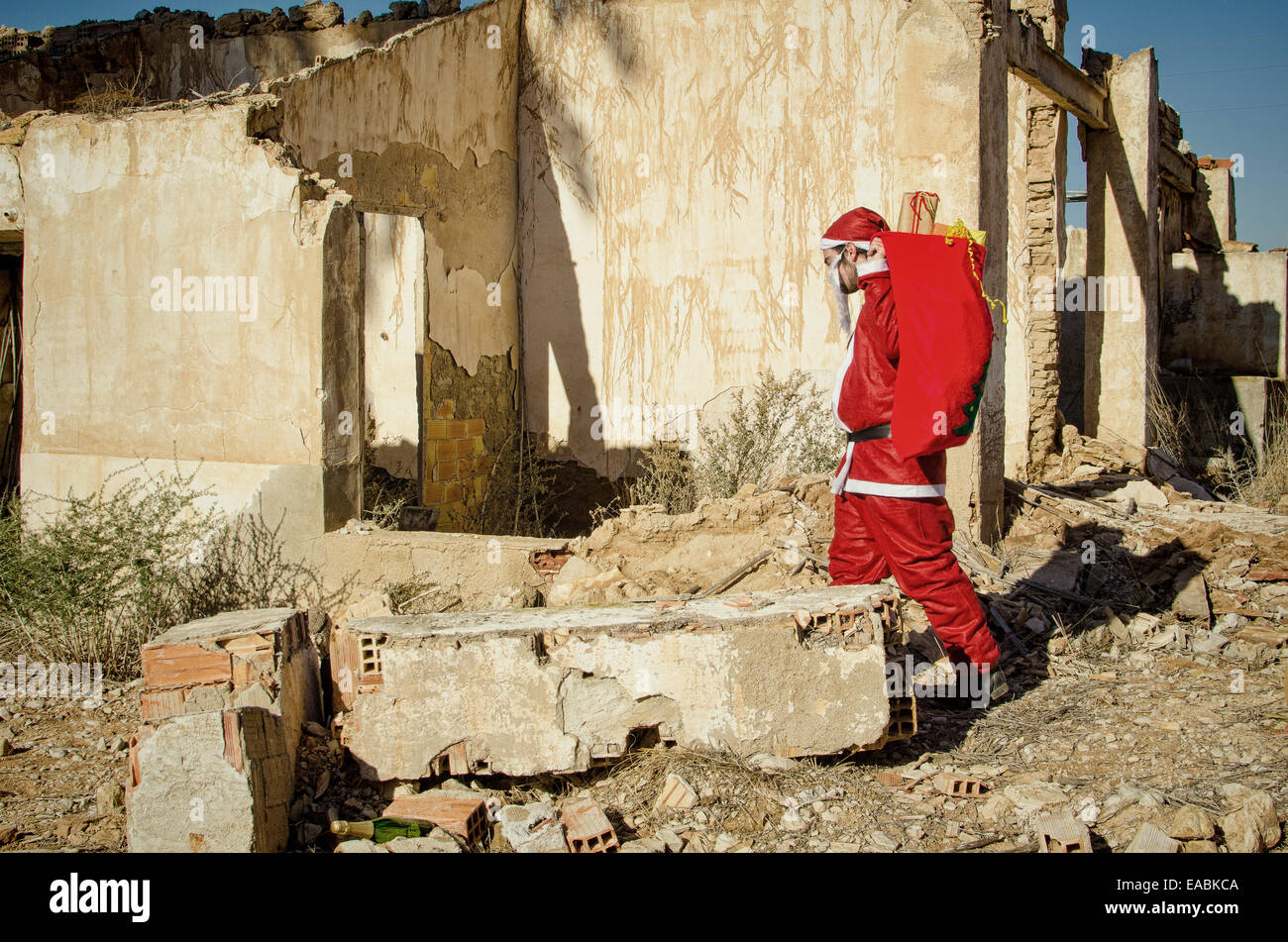 A fed up Santa trudging along with his sack Stock Photo - Alamy