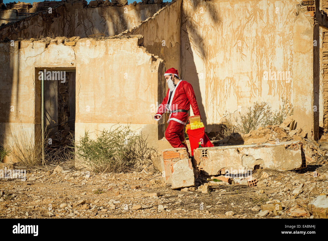 A fed up Santa trudging along with his sack Stock Photo - Alamy