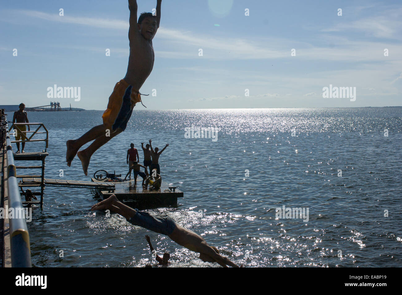 Santarem, Brazil. Boys playing in the river, diving from a wooden ...