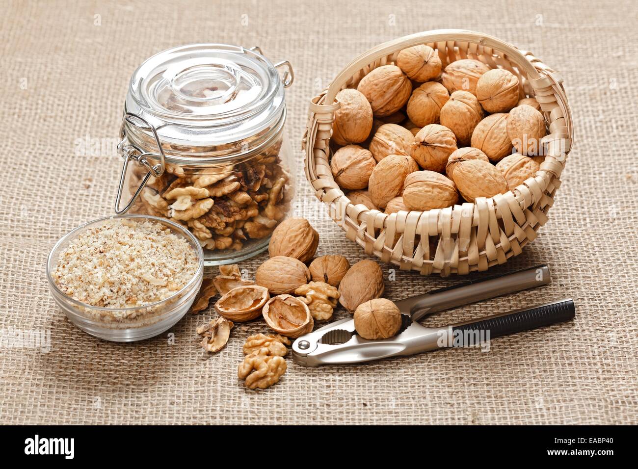 Variations of walnut, minced, whole, cracked, in jar and nut cracker ...