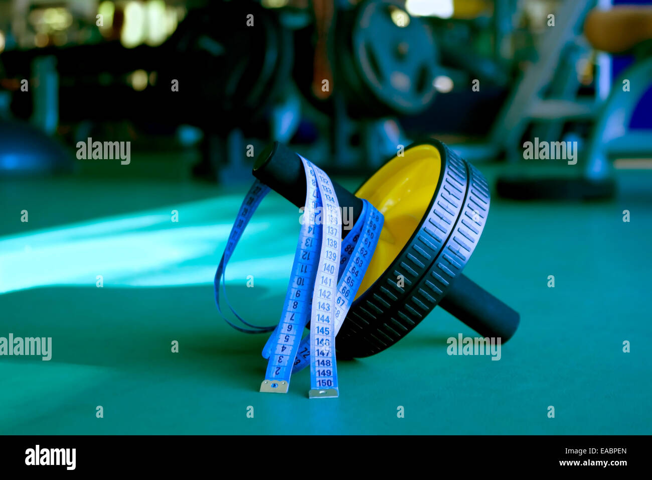 exercise wheel and tape measuring in gym Stock Photo - Alamy