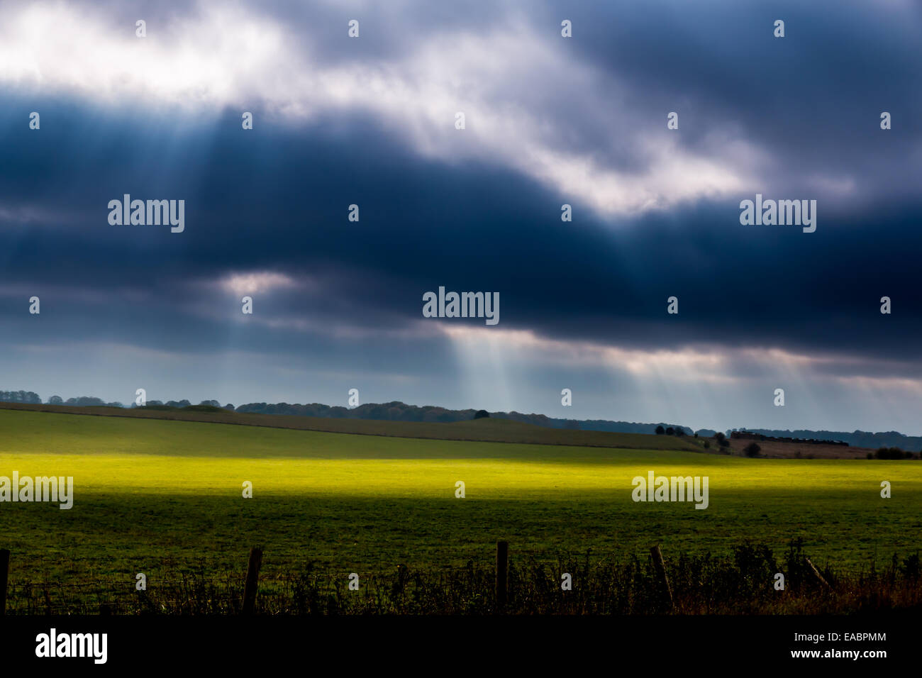 sun rays filtered through clouds on the field Stock Photo - Alamy
