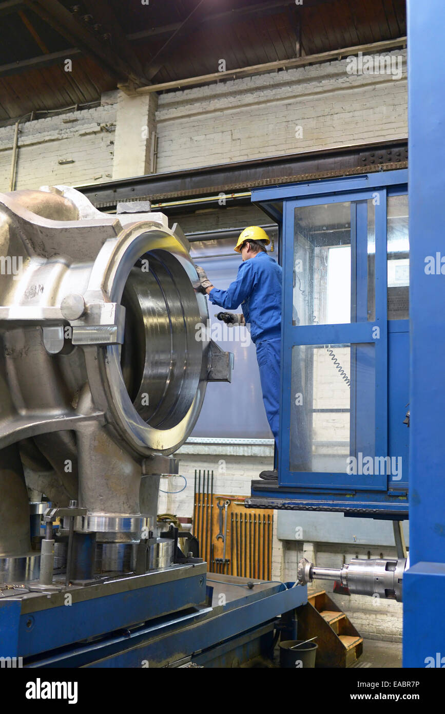 Worker at CNC machine Stock Photo - Alamy