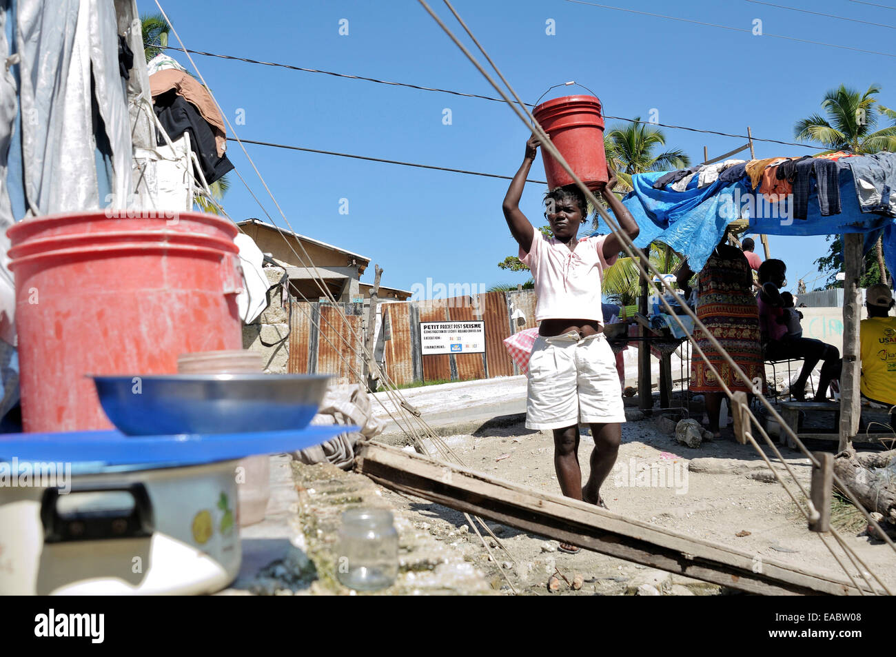Haiti Petit Goave Woman carrying clean water in bucket Stock Photo - Alamy