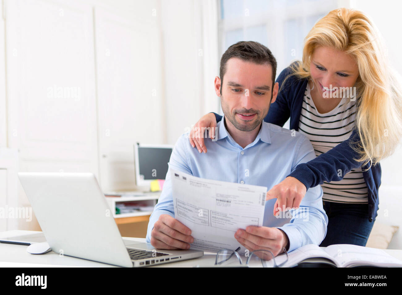 Serious young man doing paperwork hi-res stock photography and images ...