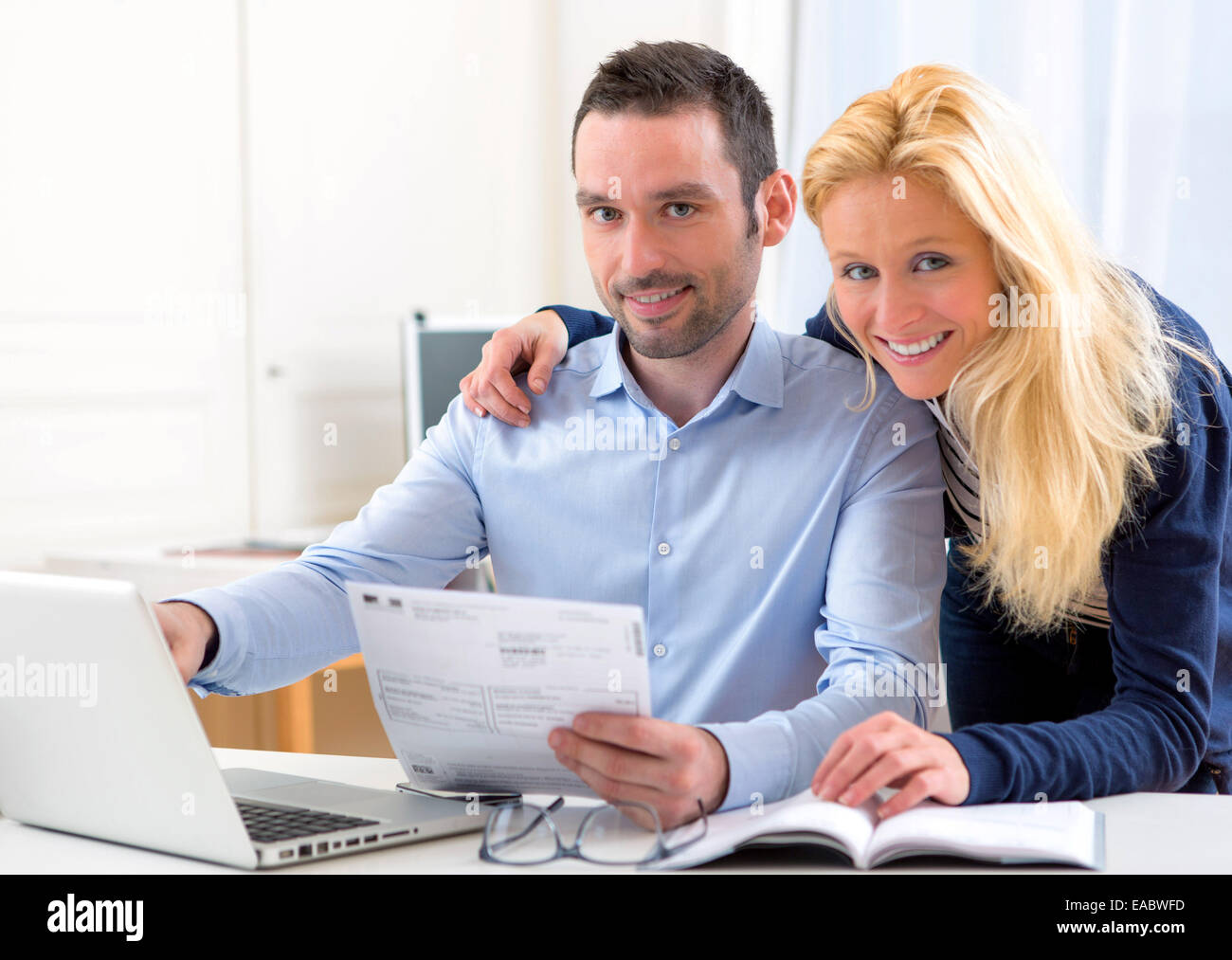 VIew of a Young attractive couple doing administrative paperwork Stock ...