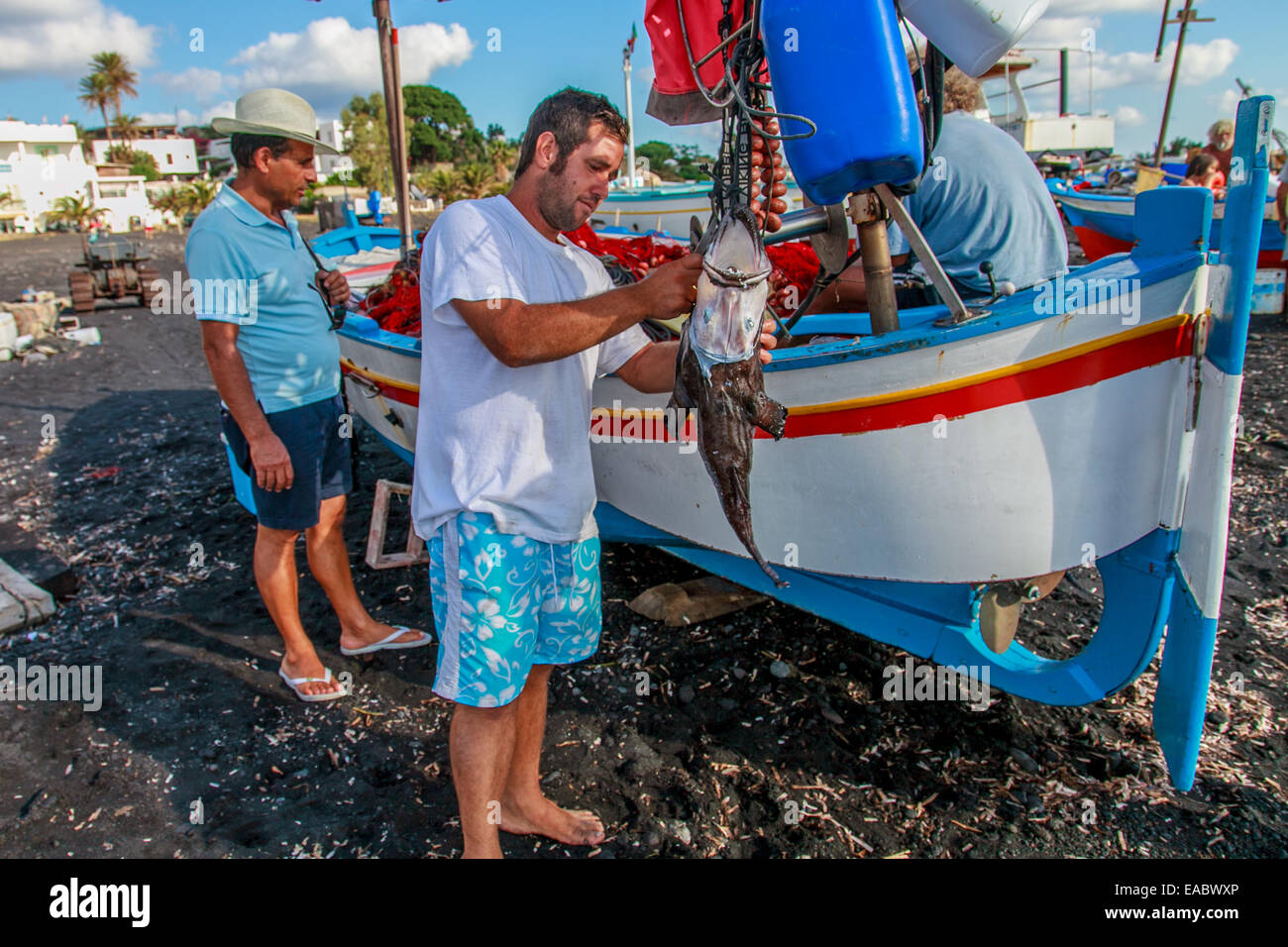 A fisherman cleaning fish Stock Photo - Alamy